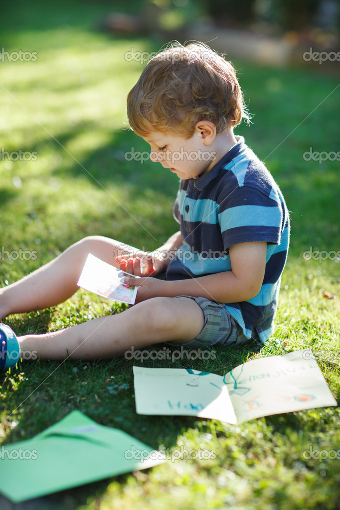Little boy reading letter Stock Photo by ©romrodinka 32464483
