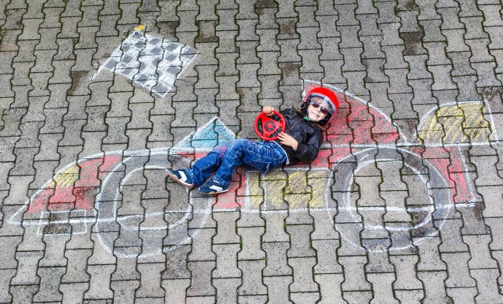 Little boy having fun with race car picture drawing with chalk — Stock ...
