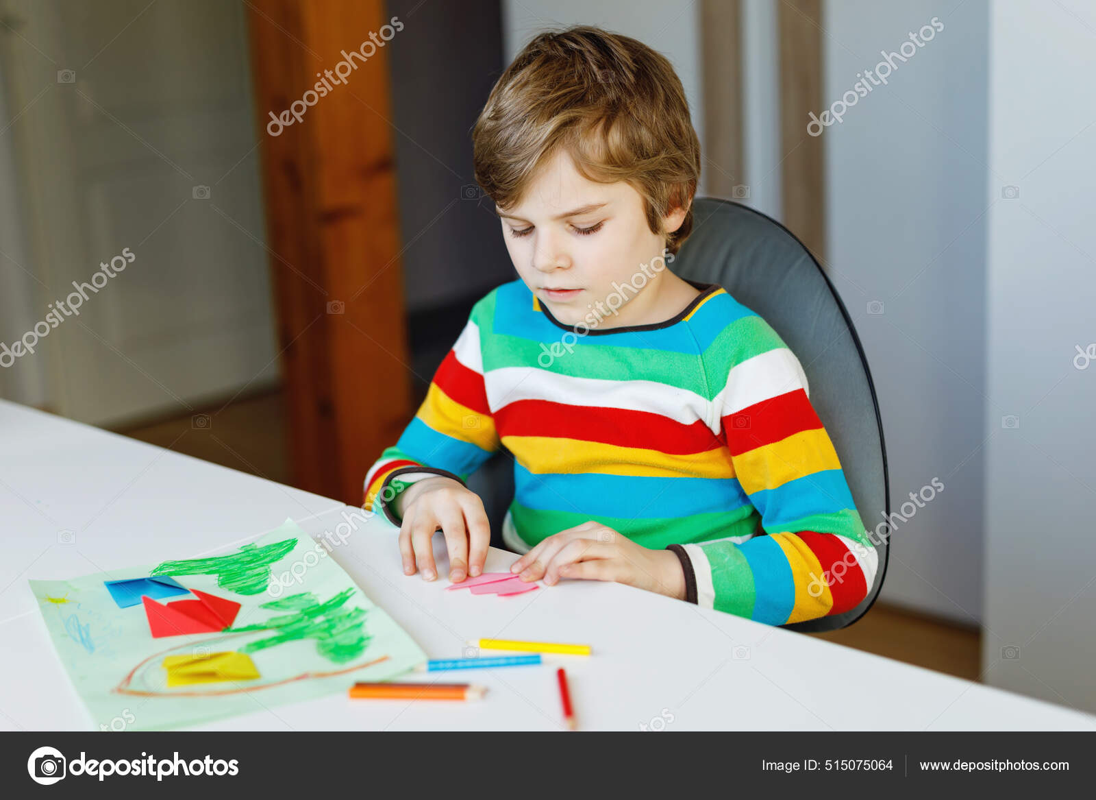 Little kid boy making paper origami tulip flowers for a postcard for ...