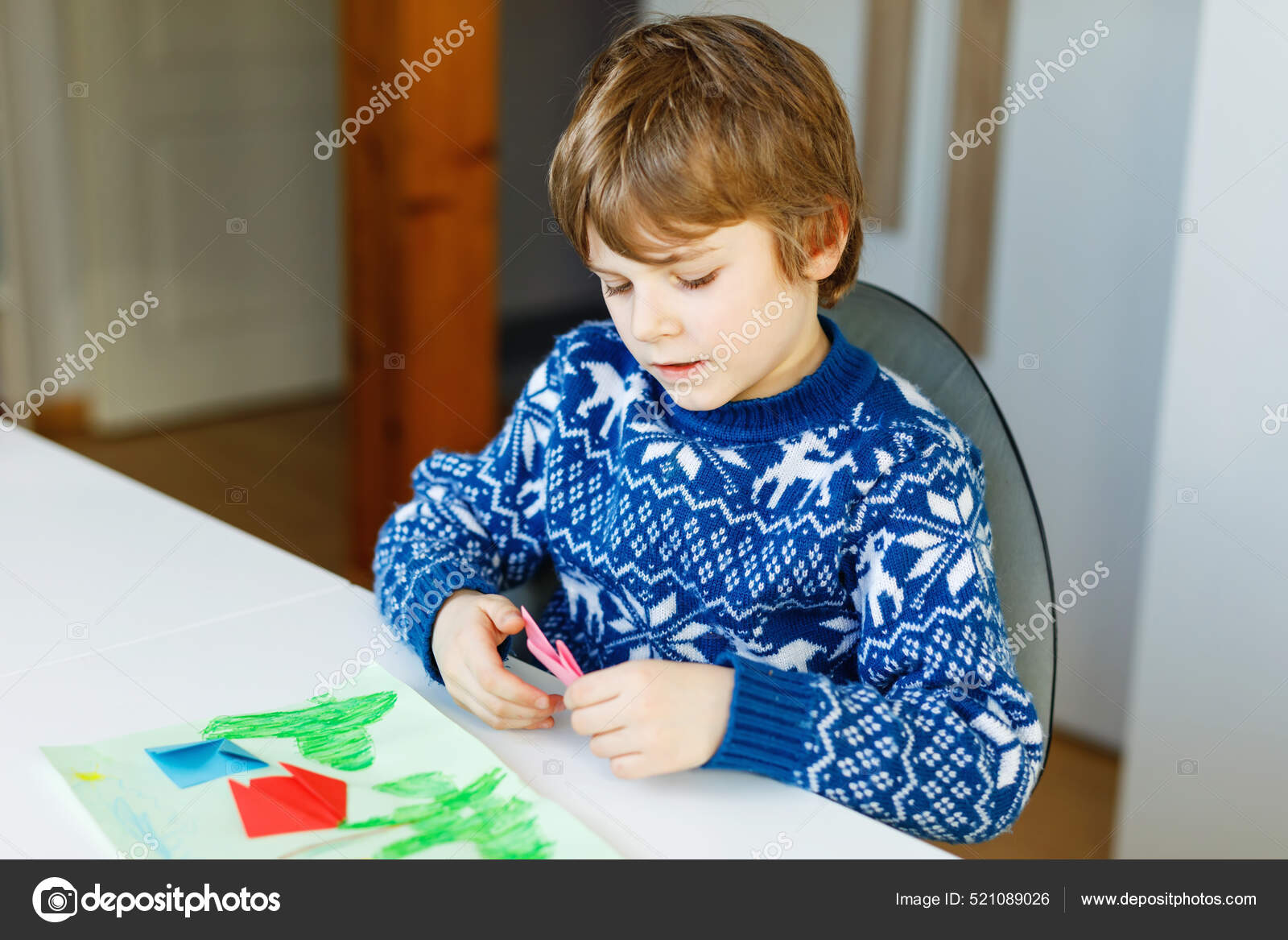 Little kid boy making paper origami tulip flowers for a postcard for ...