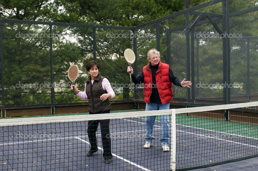 Man and woman playing paddle platform tennis — Stock Photo © rjlerich ...
