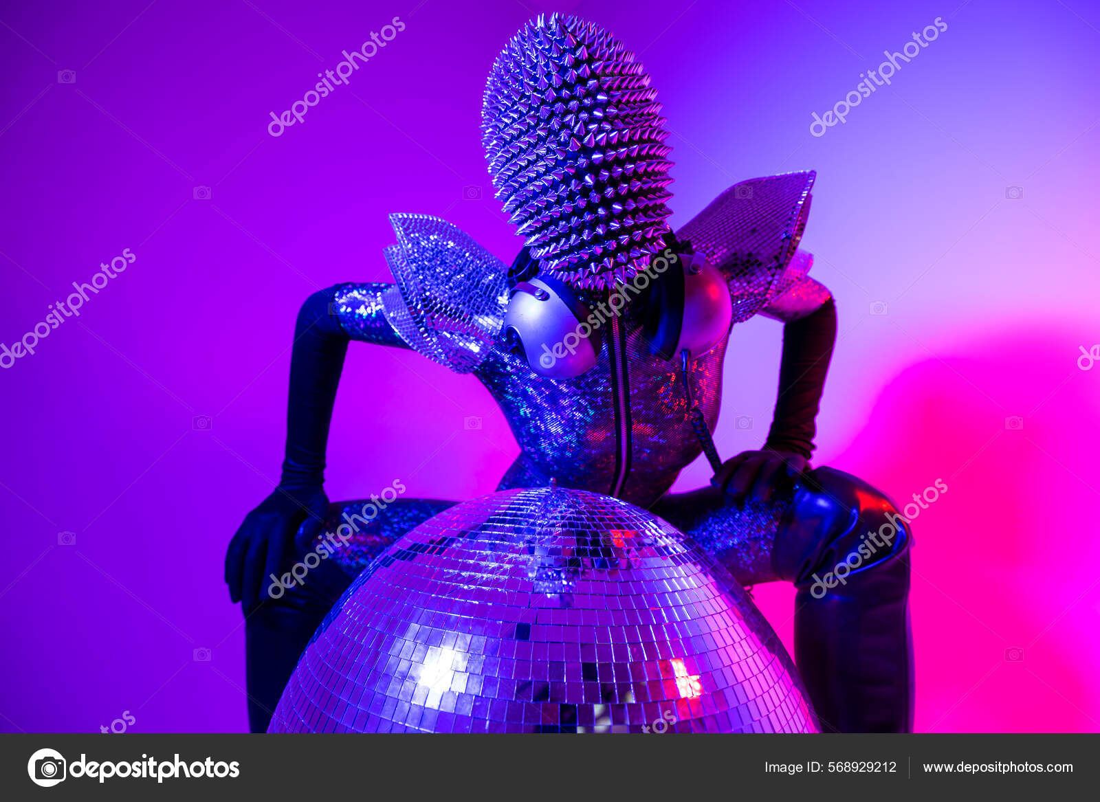 Female dancer with spiky mask against colourful background Stock Photo ...