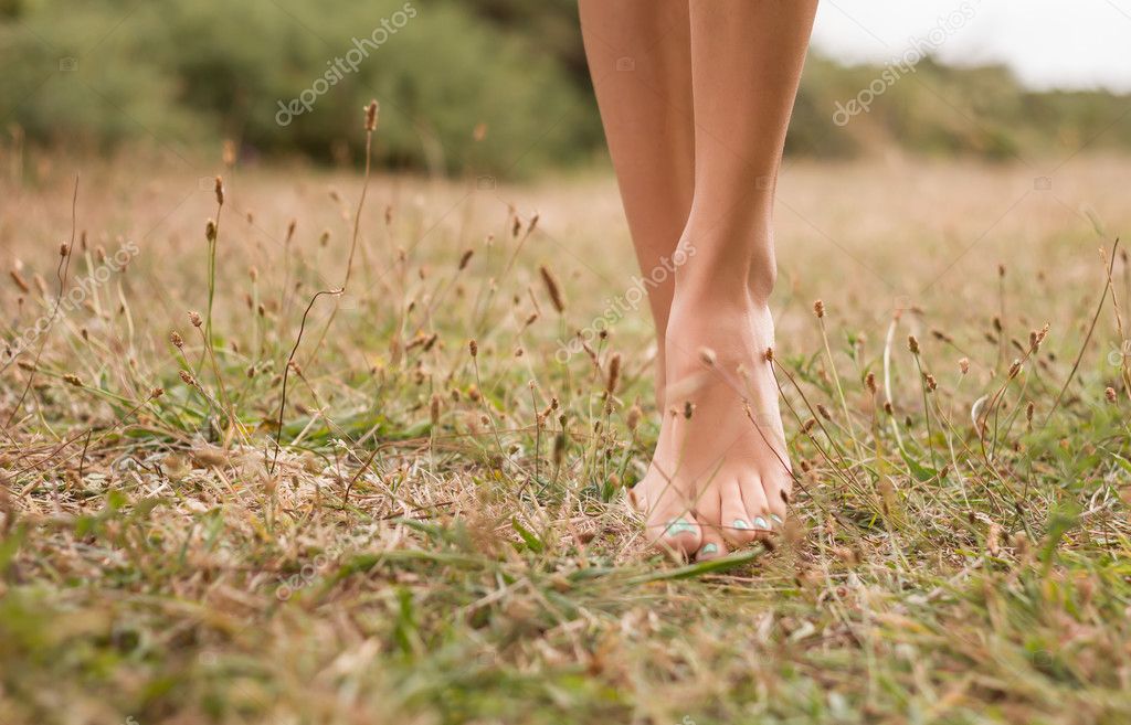 Young female legs walking on the grass — Stock Photo © doble.dphoto ...