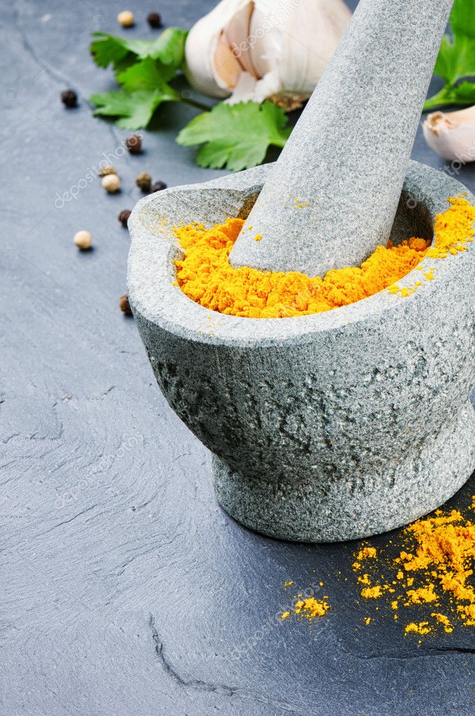 Mortar and pestle with curry powder Stock Photo by ©paulgrecaud 23199694