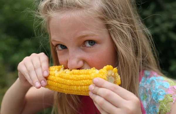 Little girl eating corn Stock Photo by ©mallivan 79610850