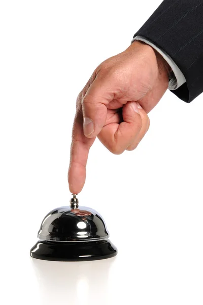 Hand ringing in service bell on wooden table on black background Stock ...