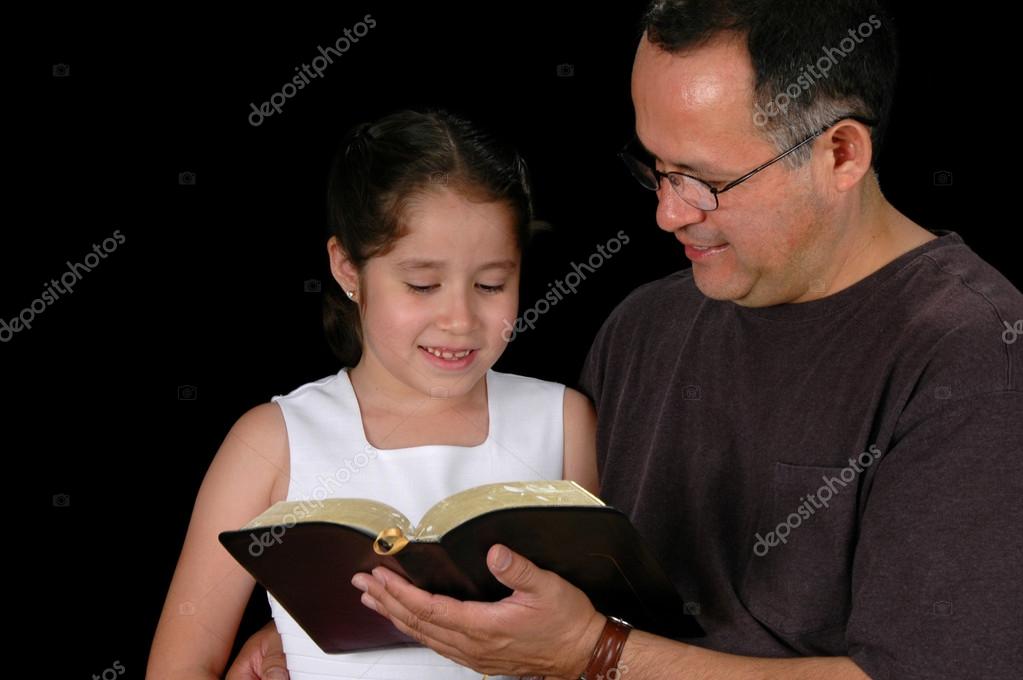 Father Reading Bible to Daughter — Stock Photo © ginosphotos1 #16639811