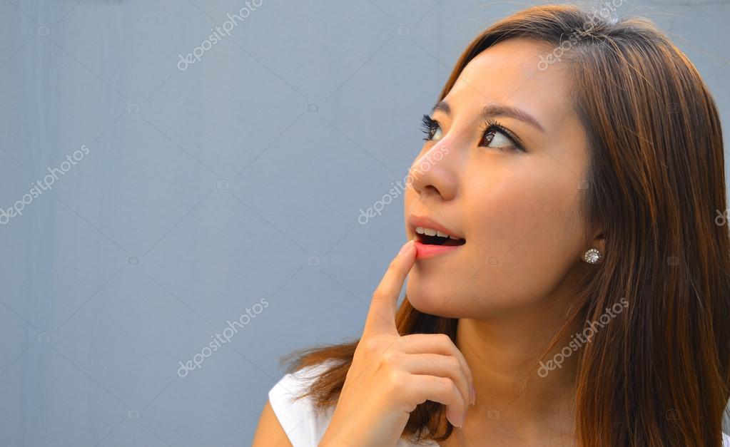 Beautiful young asian woman thinking — Stock Photo © blueperfume #13485544
