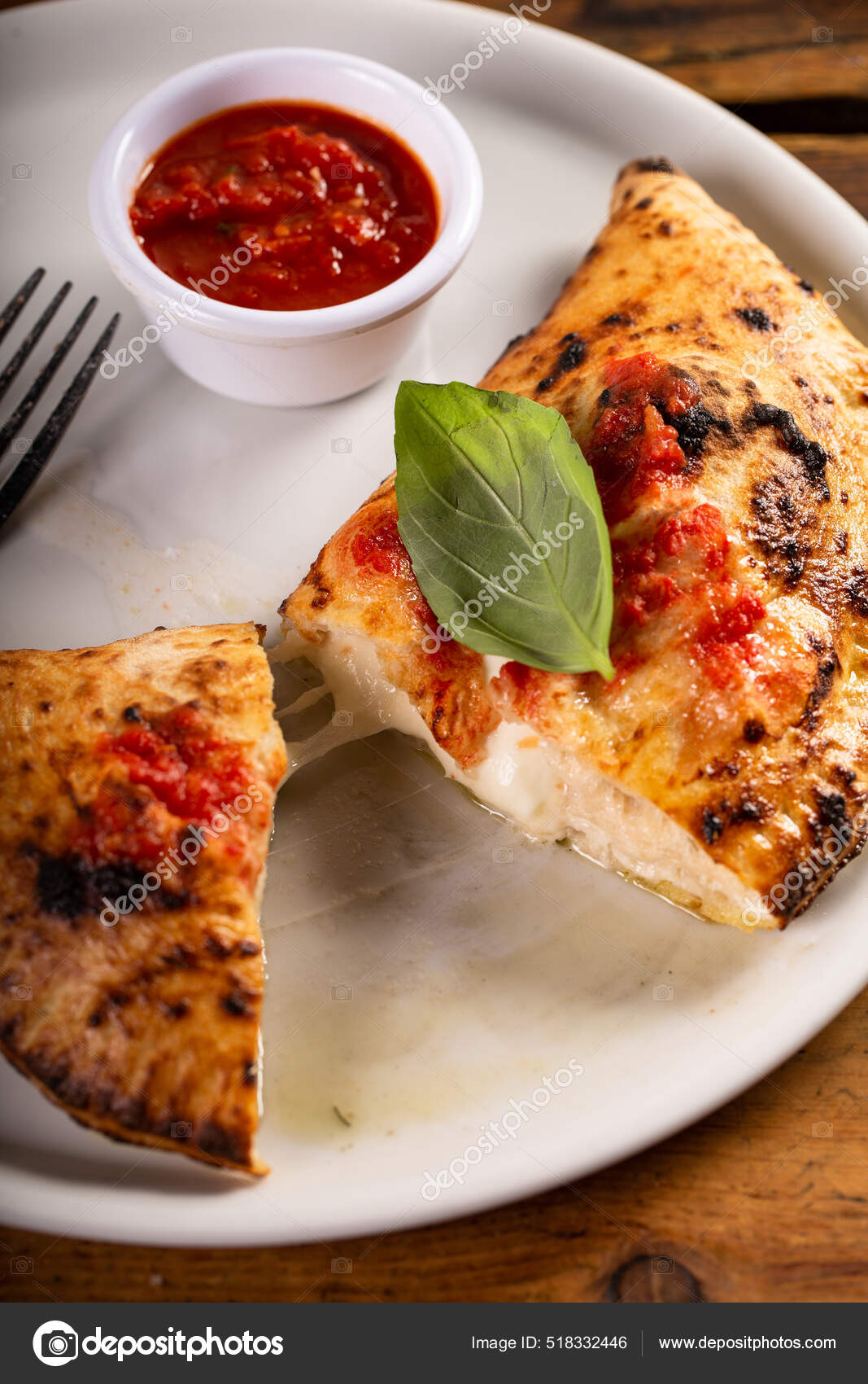 Italian calzone with marinara sauce whole on a plate Stock Photo by ...