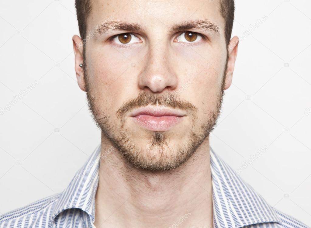 Young mans face, serious expression — Stock Photo © tommasolizzul #13764564