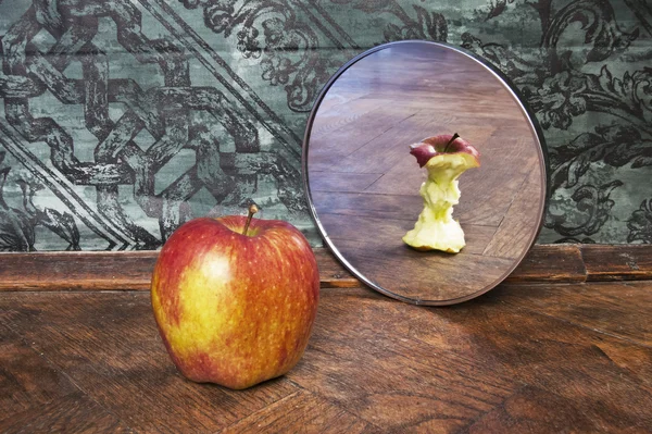 Surrealistic picture of an apple reflecting in the mirror - Stock Image ...