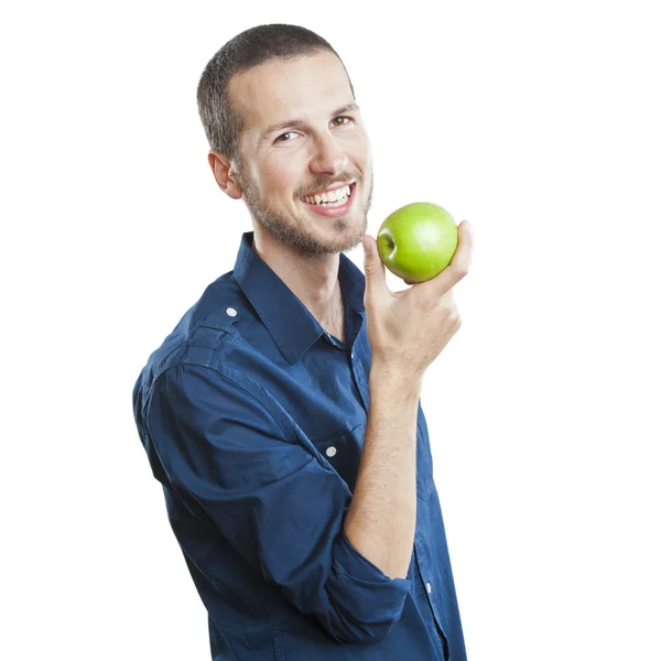 Cheerful beautiful man eating apple, isolated over white background ...