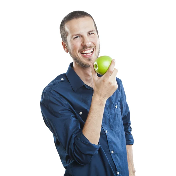 Cheerful beautiful man eating apple, isolated over white background ...