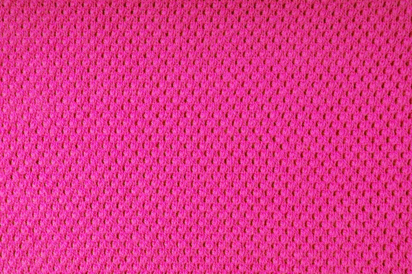 Close up background of knitted wool fabric with dots pattern. Bright ...