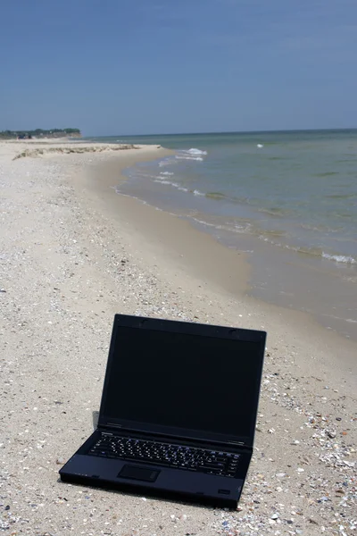 Laptop on beach Stock Photo by ©smithore 11984676