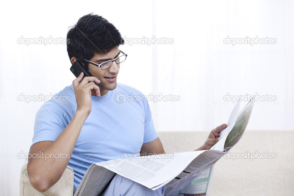 Young Indian man reading newspaper — Stock Photo © iphemant #46044743 Young Indian man reading newspaper — Stock Photo © iphemant #46044743