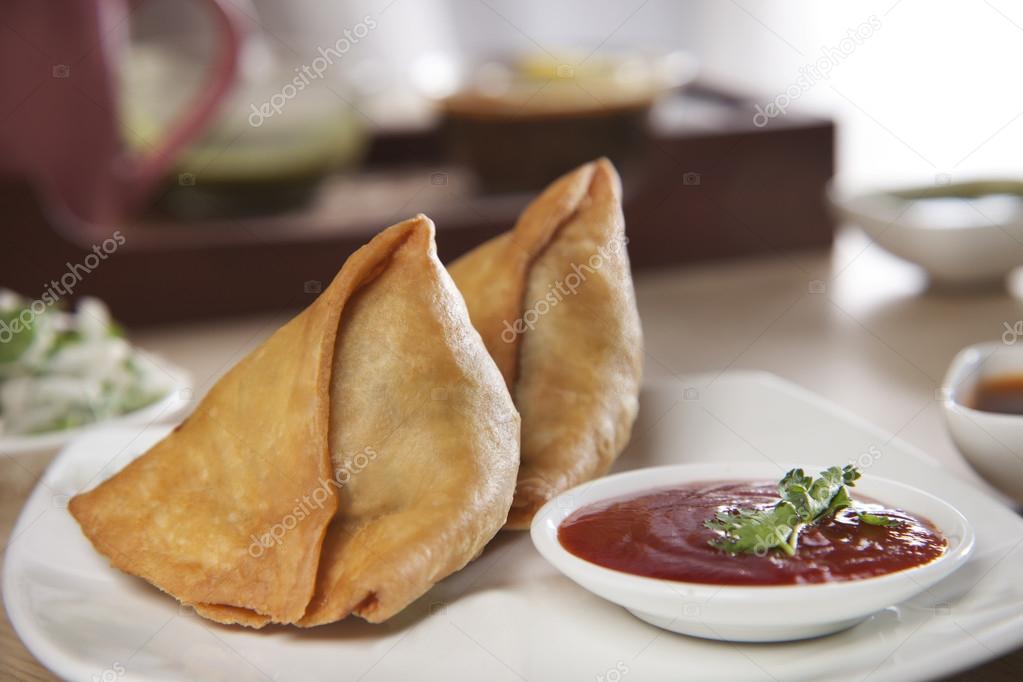 Samosa with tomato ketchup — Stock Photo © IndiaPix #47493237