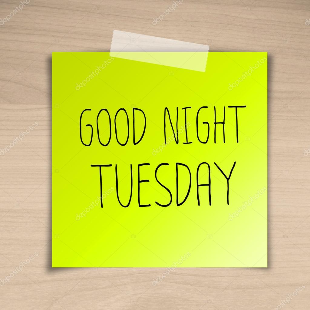 Good night tuesday sticky paper on brown wood background texture ...