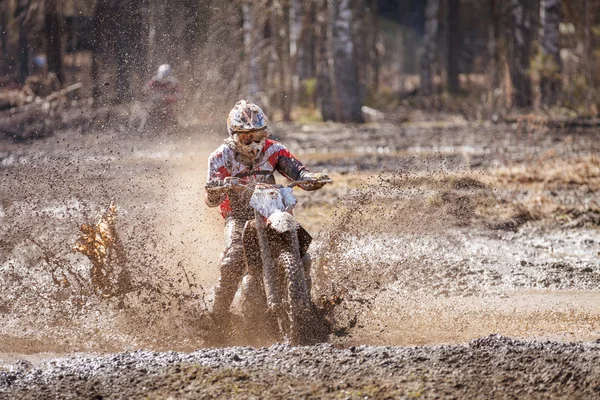 Motocross driver in mud - Stock Image - Everypixel