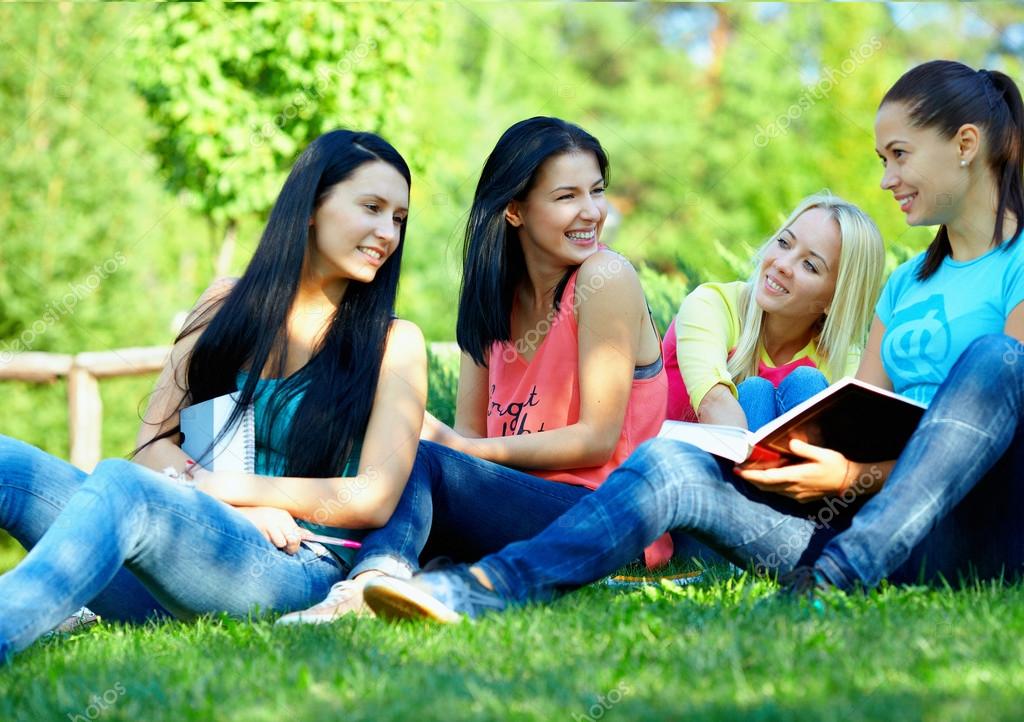 Four smiling student girls studying in green park — Stock Photo ...