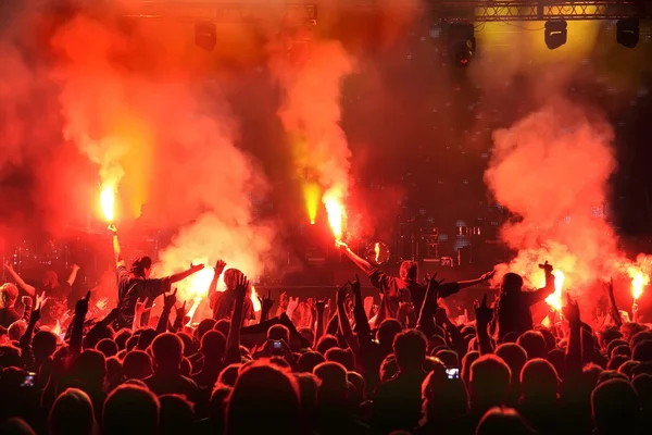 Cheering crowd at concert, musicians on the stage - Stock Image ...