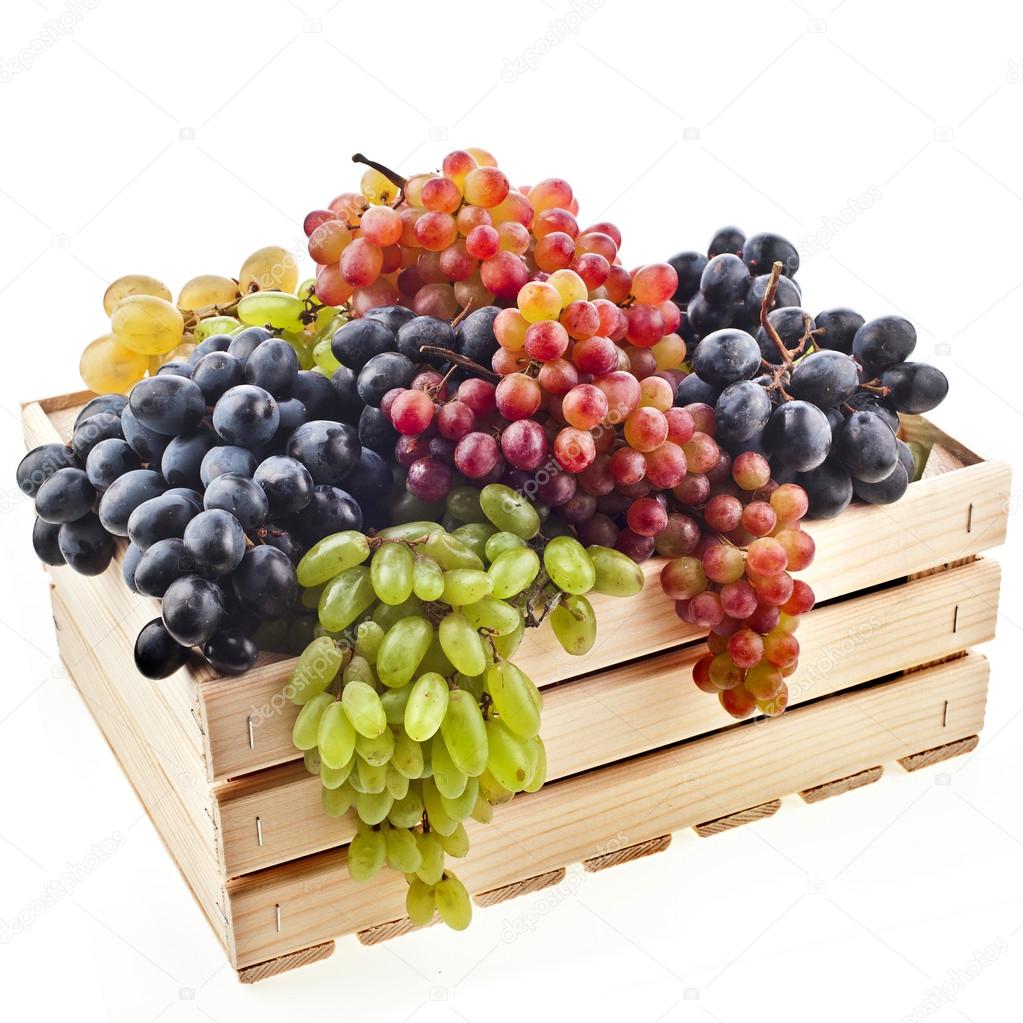 Colorful mixed grapes in a wooden crate box isolated on a white ...