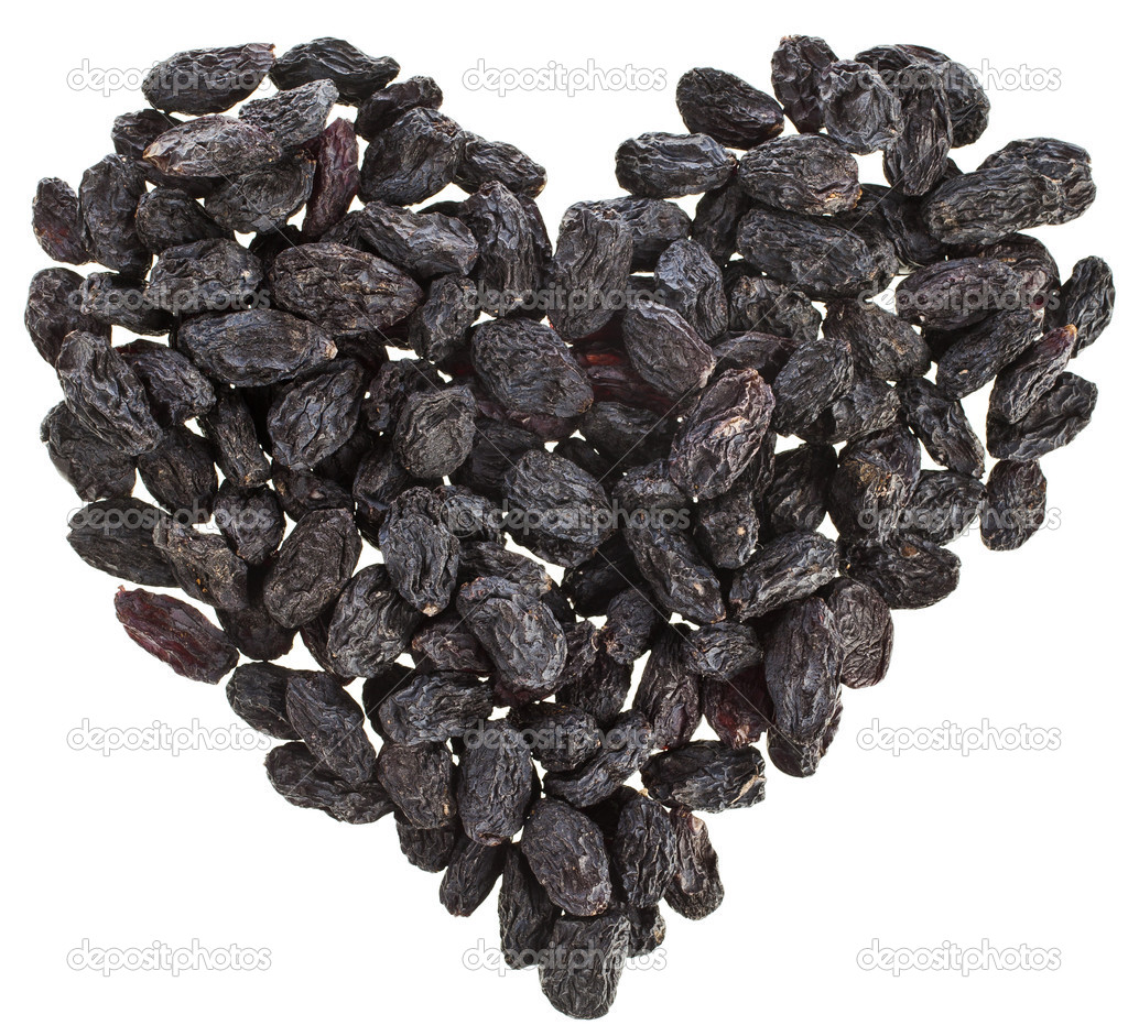Black Dried Grape Raisins in shape heart isolated on white background ...