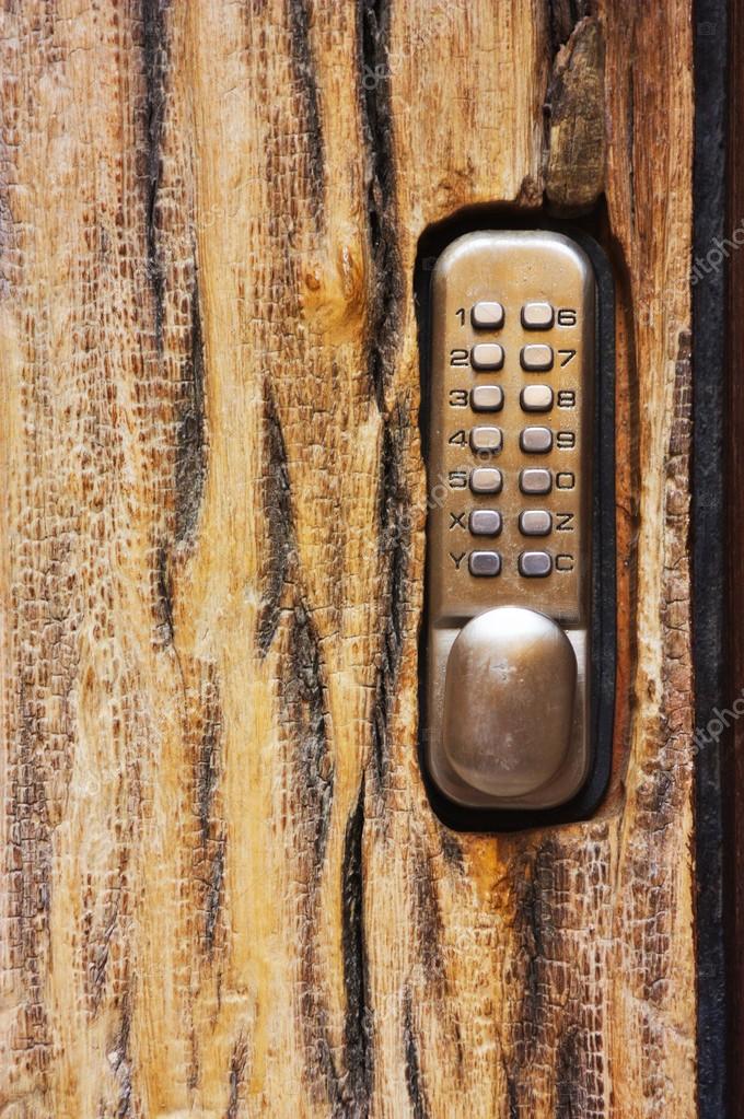 PIN keypad with numbers and letters carved in the wooden door — Stock ...