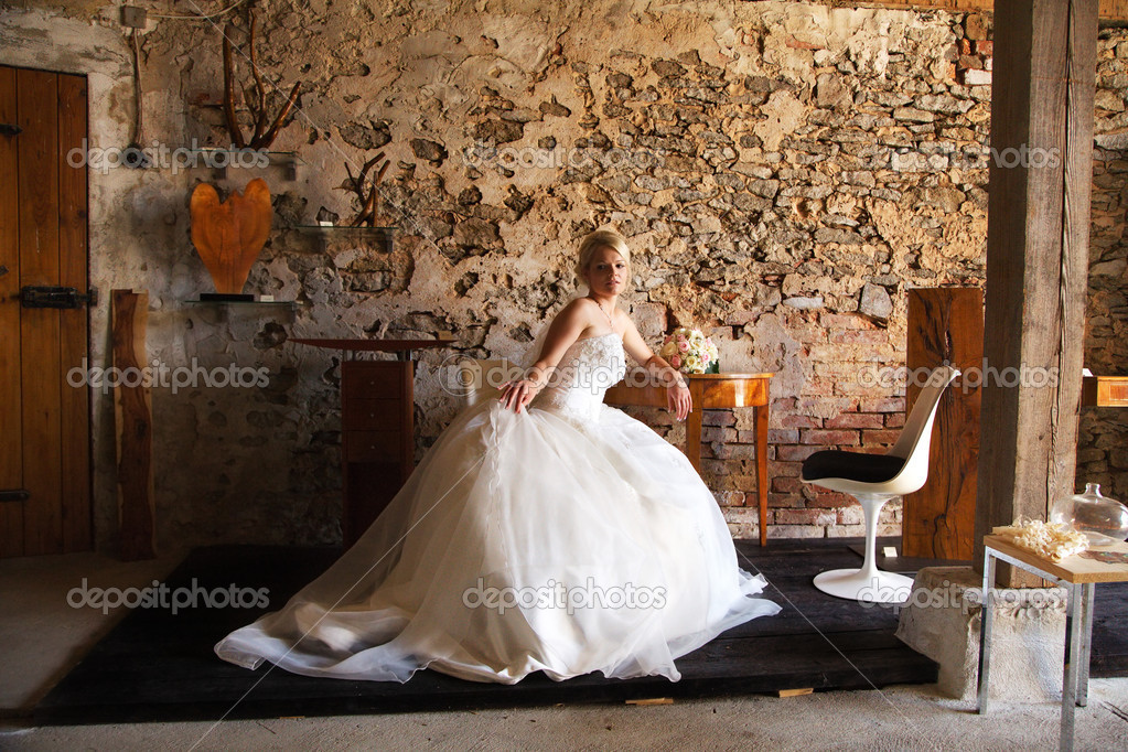 Beatifull bride sitting on a chair Stock Photo by ©Nick_Freund 31497733
