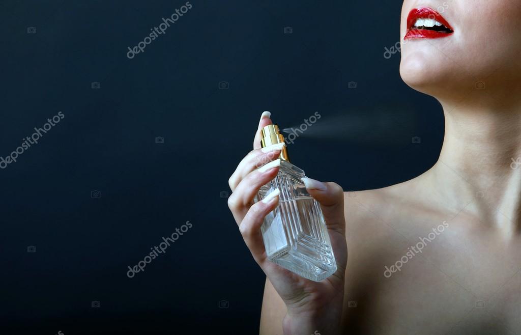 Smiling girl spray the perfume of a bottle — Stock Photo © Knut_Wiarda ...