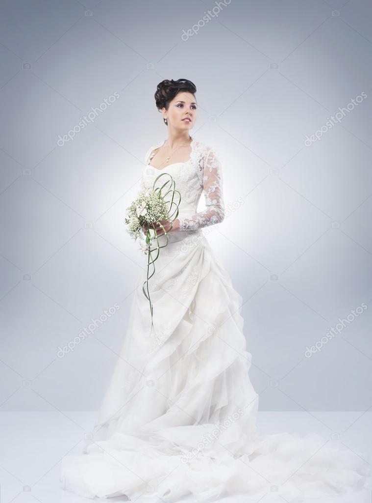 Young and beautiful bride standing with the flower bouquet Stock Photo ...