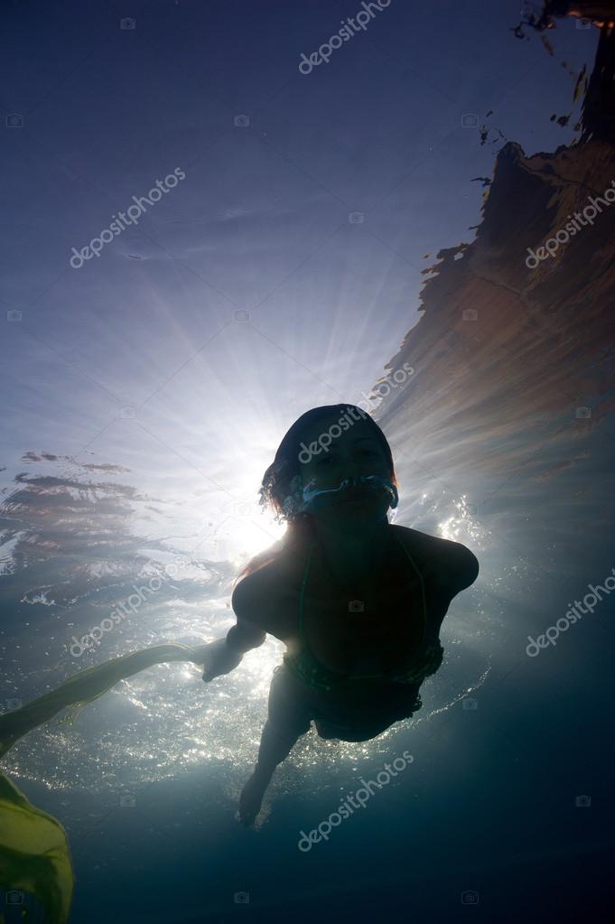 Woman silhouette underwater in swimming pool with back light — Stock ...