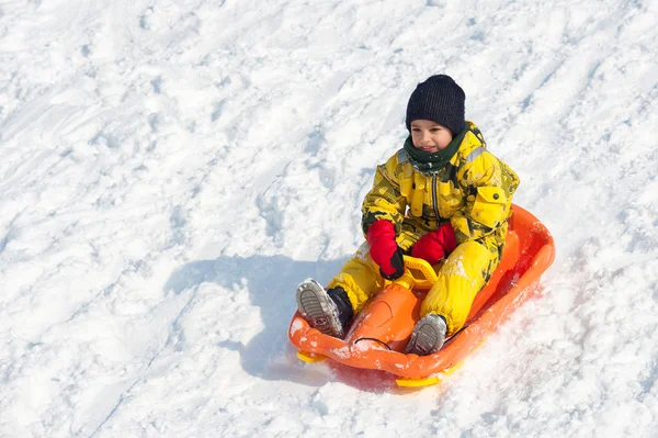 Two kids sliding with sledding in the snow Stock Photo by ©pio3 14976577