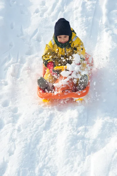 Two kids sliding with sledding in the snow Stock Photo by ©pio3 14976577