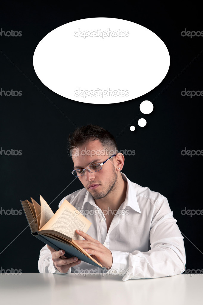 Young man reading a book against black background with copy space ...