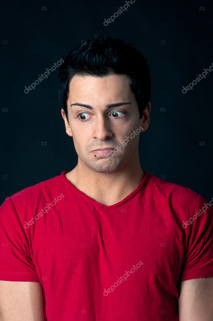 Man portrait with doubtful expression on dark background Stock Photo by ...