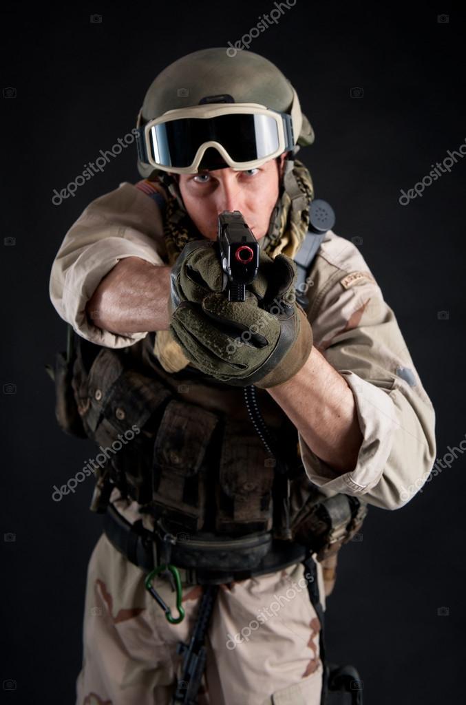 Soldier pointing gun against black background Stock Photo by ©pio3 15654667