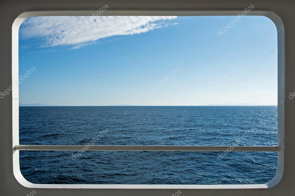 Ship windows with a relaxing seascape and blue sky view Stock Photo by ...