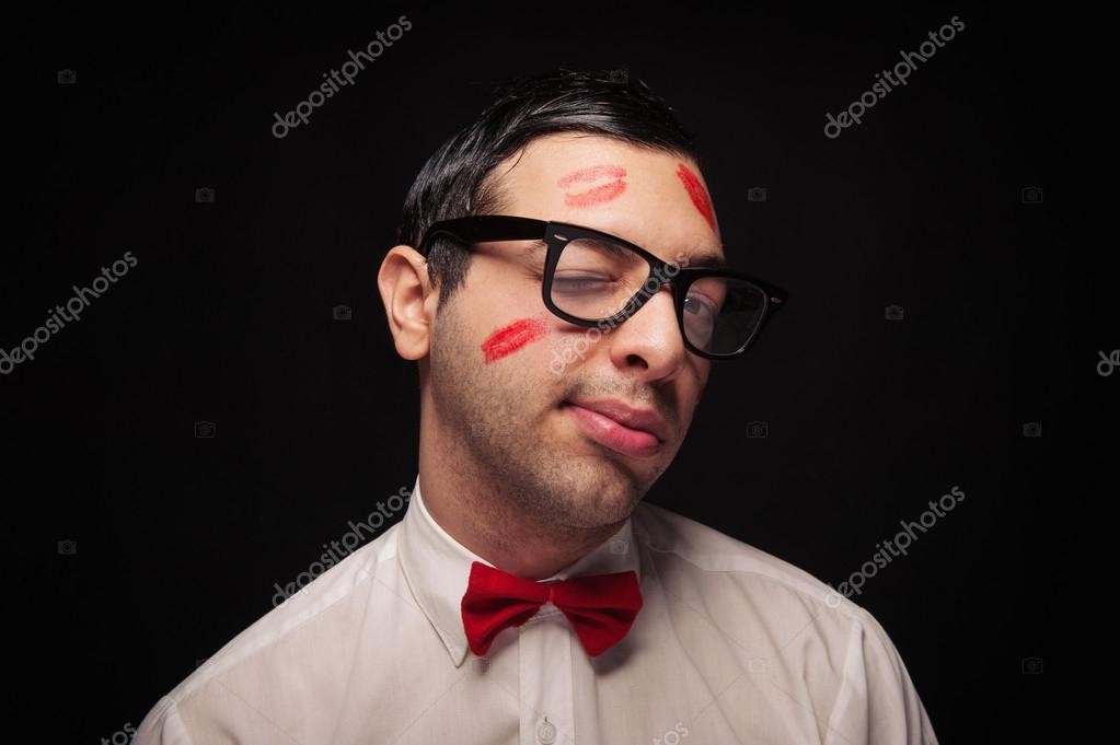 Funny portrait of young nerd with kiss imprints blinking eye isolated ...