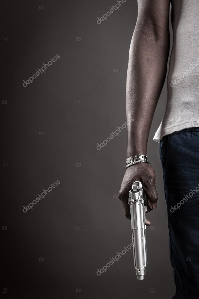 Killer with gun close up over dark background with copyspace. — Stock ...
