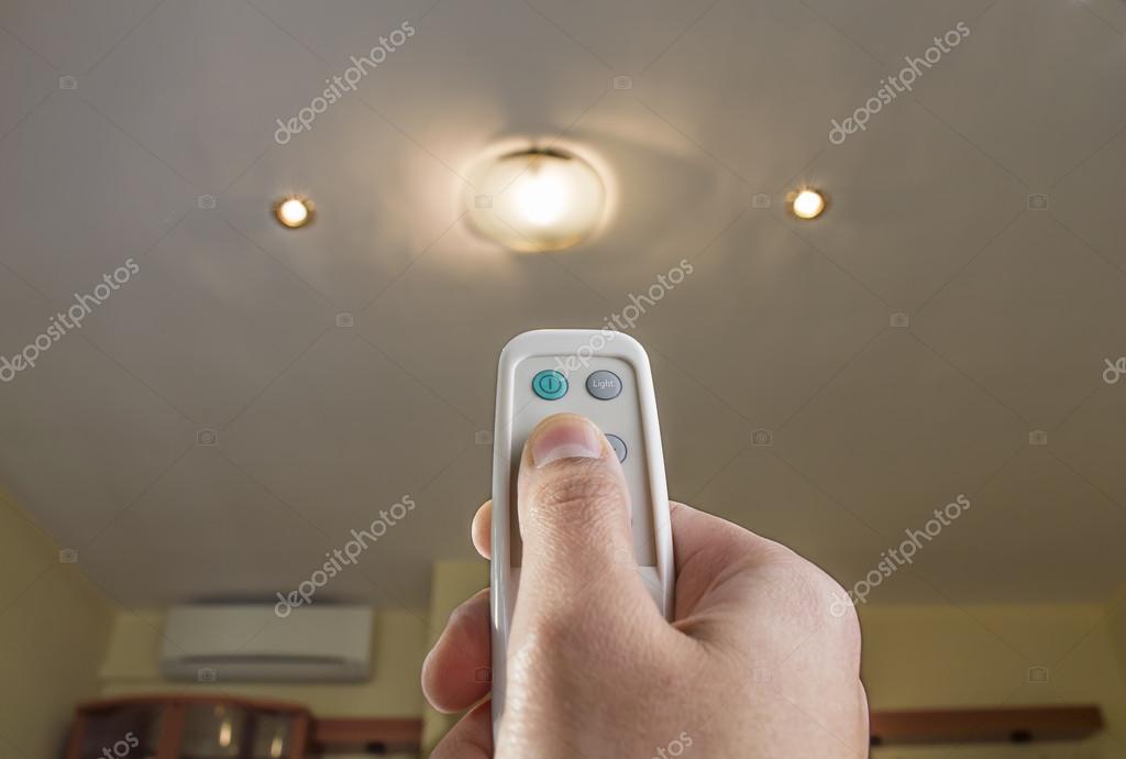 Remote control controlling an light — Stock Photo © cunaplus #37922273