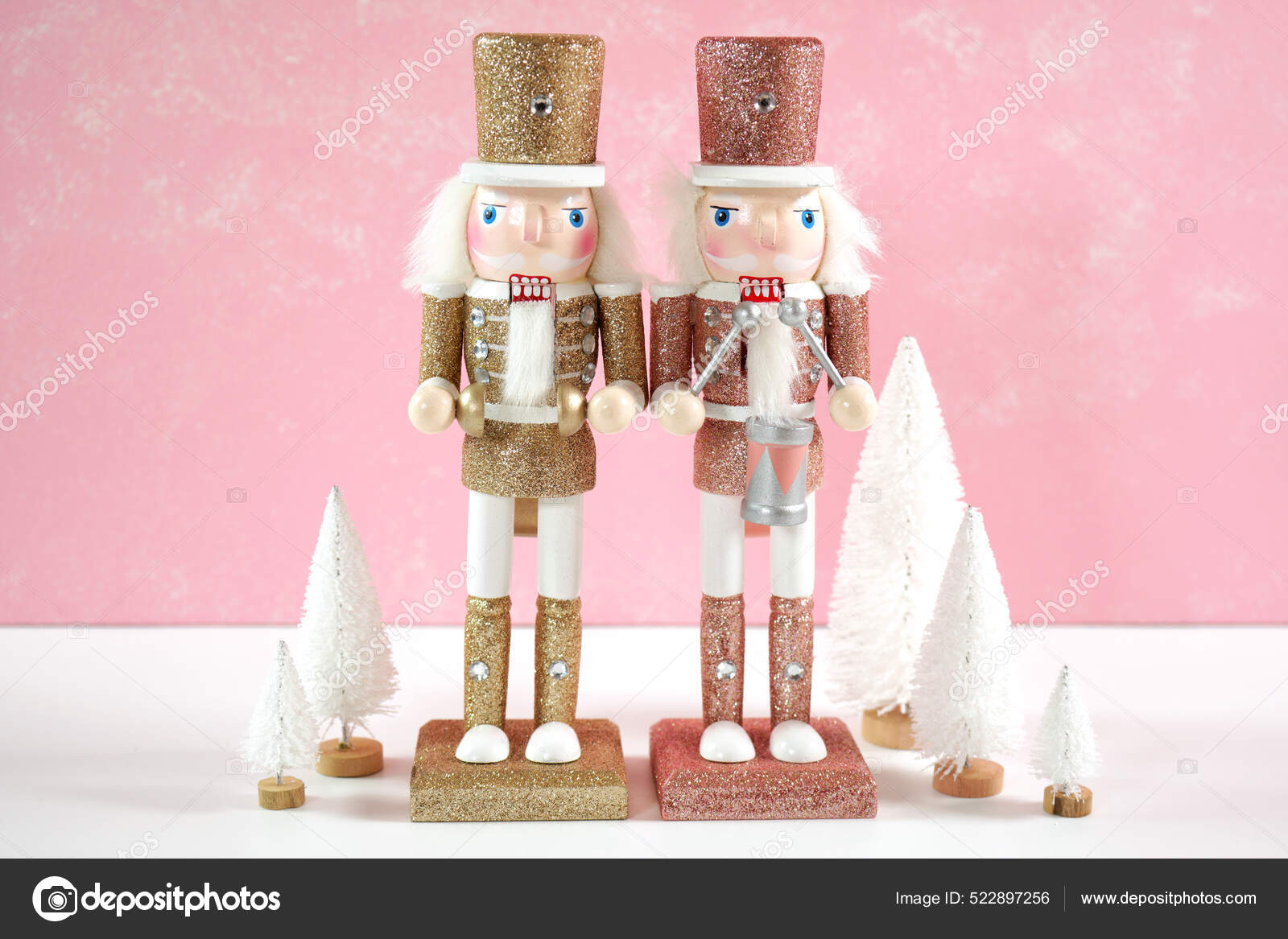Pink Christmas nutcracker ornaments against a pink and white background ...