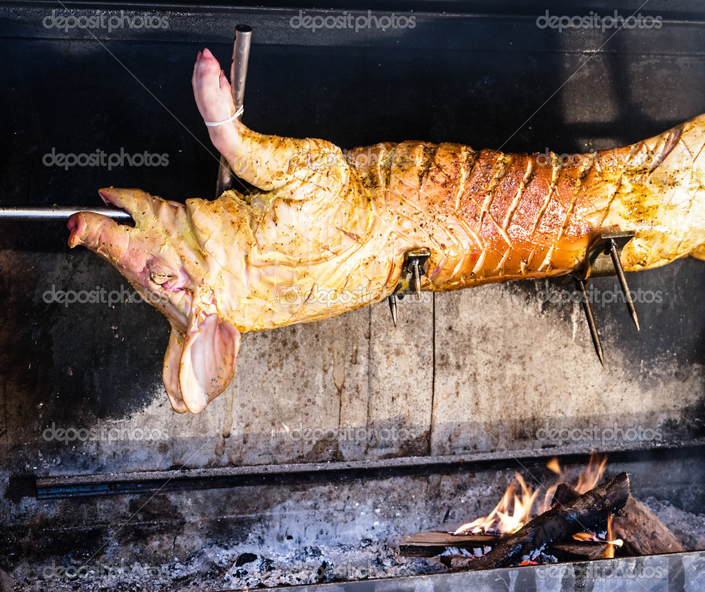 Young pig roasting — Stock Photo © foottoo #19484143