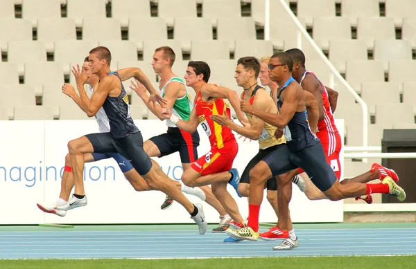 Competitors on start of 100m of Decathlon - Stock Image - Everypixel