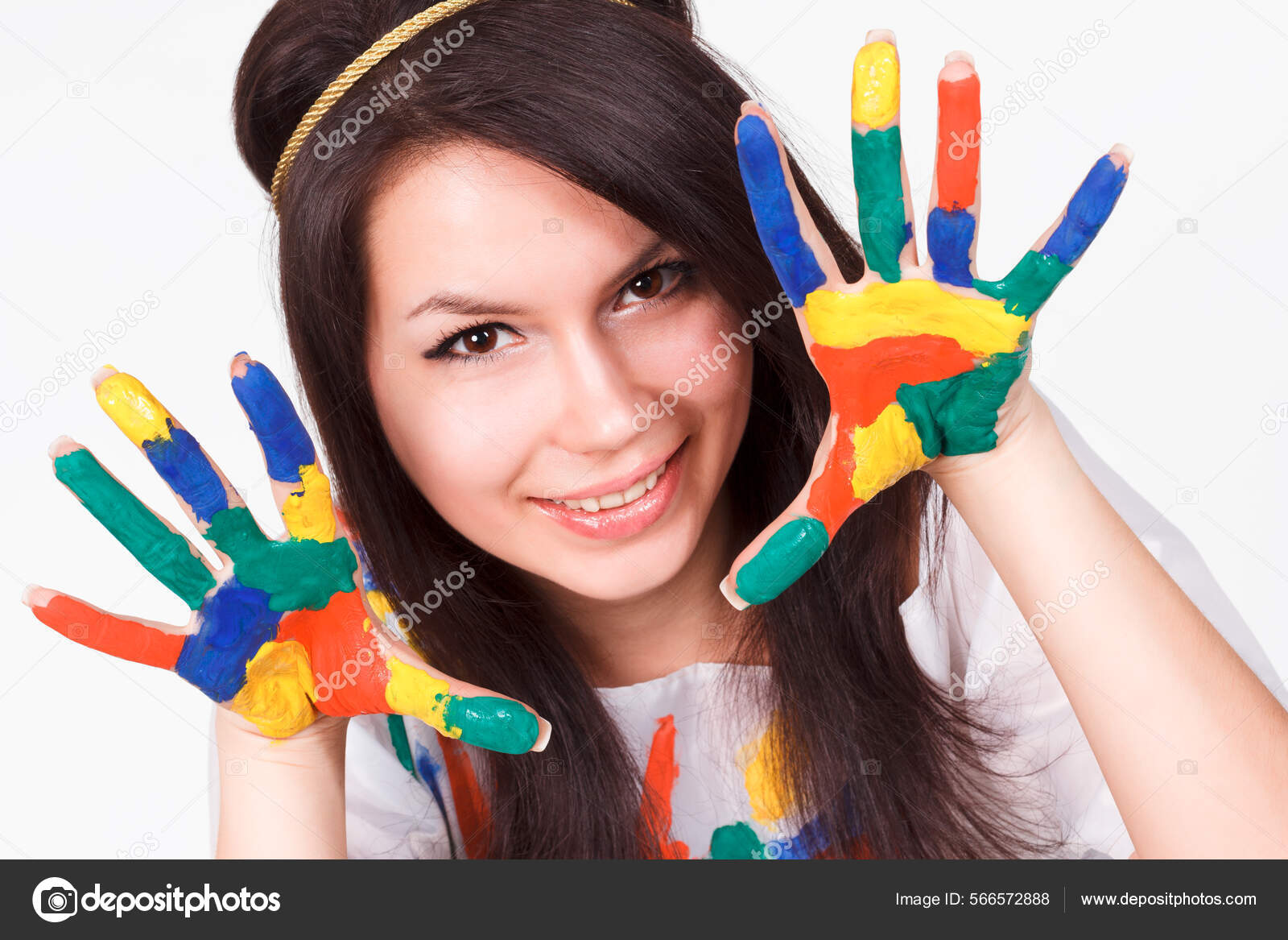 Young woman with hands painted with colorful paints, ready for ...