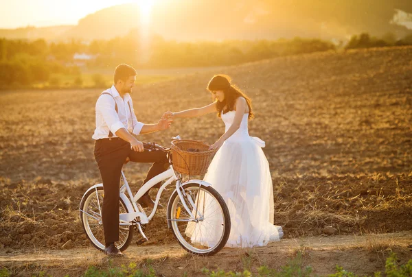 Bride and groom with a white wedding bike - Stock Image - Everypixel