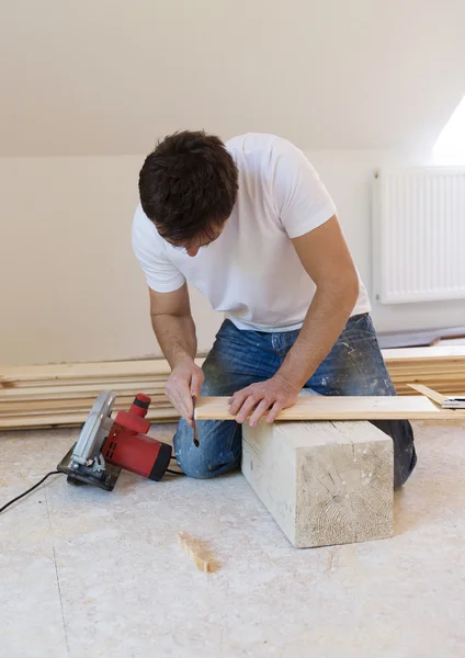 Handyman installing wooden floor - Stock Image - Everypixel