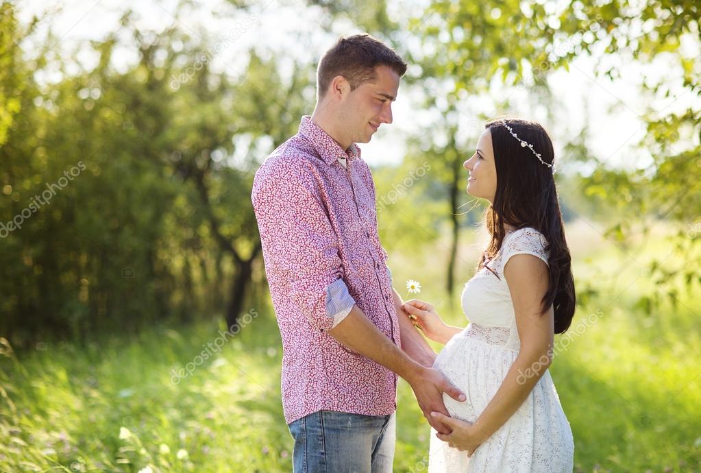 Pregnant couple hugging Stock Photo by ©halfpoint 50796081