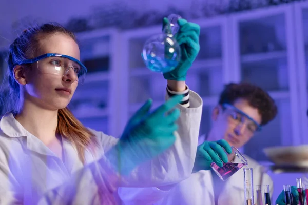 A science student doing chemical experiment in the laboratory at ...