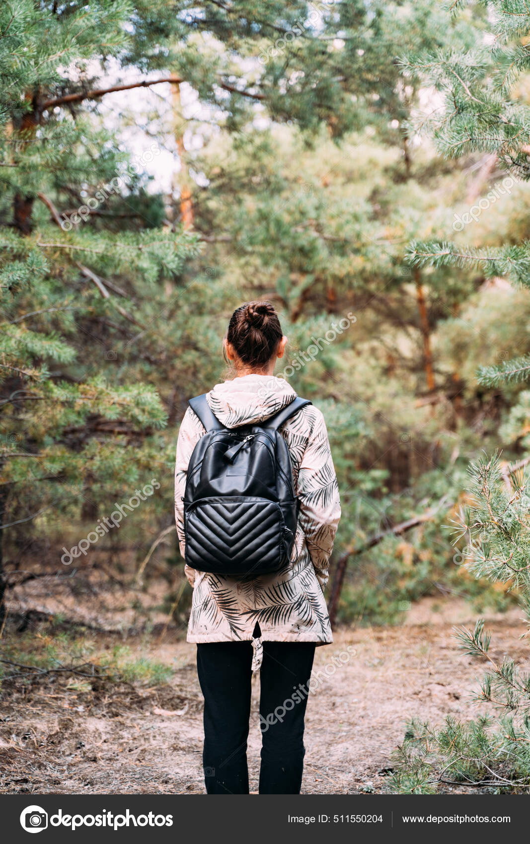 Woman in forest on a sunny day. Pine high trees. Close to nature ...